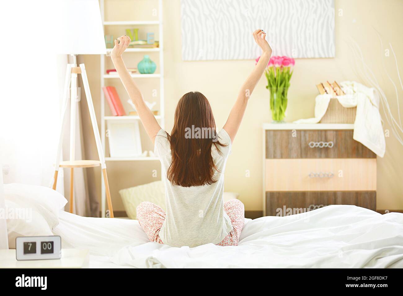 Beautiful young girl waking up after a night sleep Stock Photo - Alamy