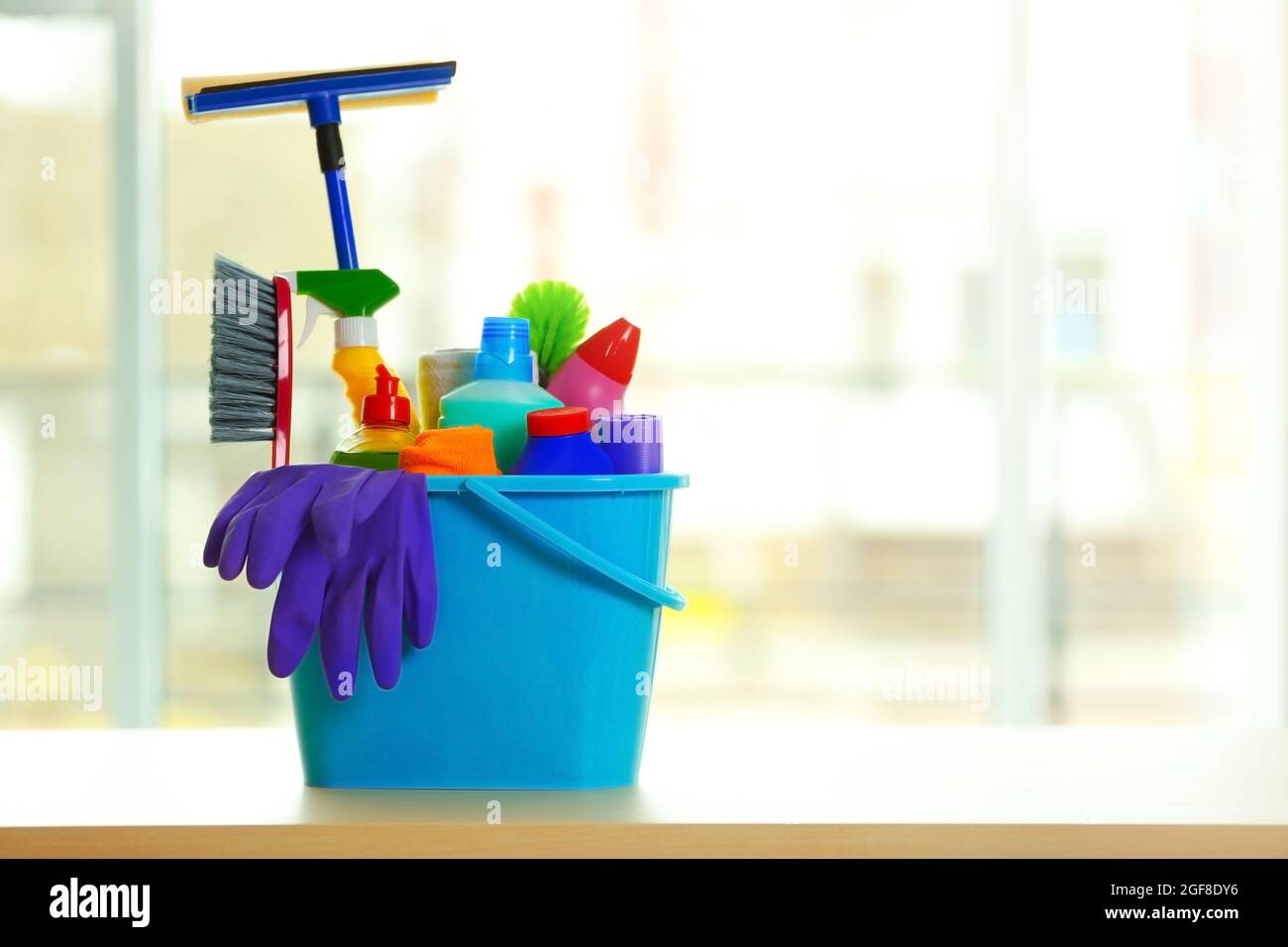 Cleaning set with products and tools in blue bucket Stock Photo - Alamy