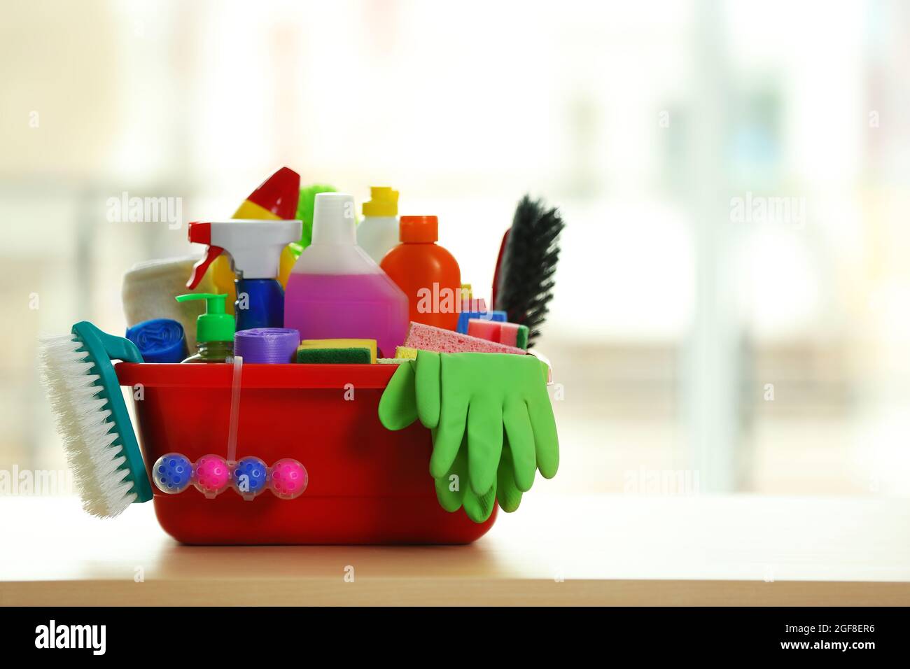 Cleaning set with products and tools in red tub Stock Photo - Alamy