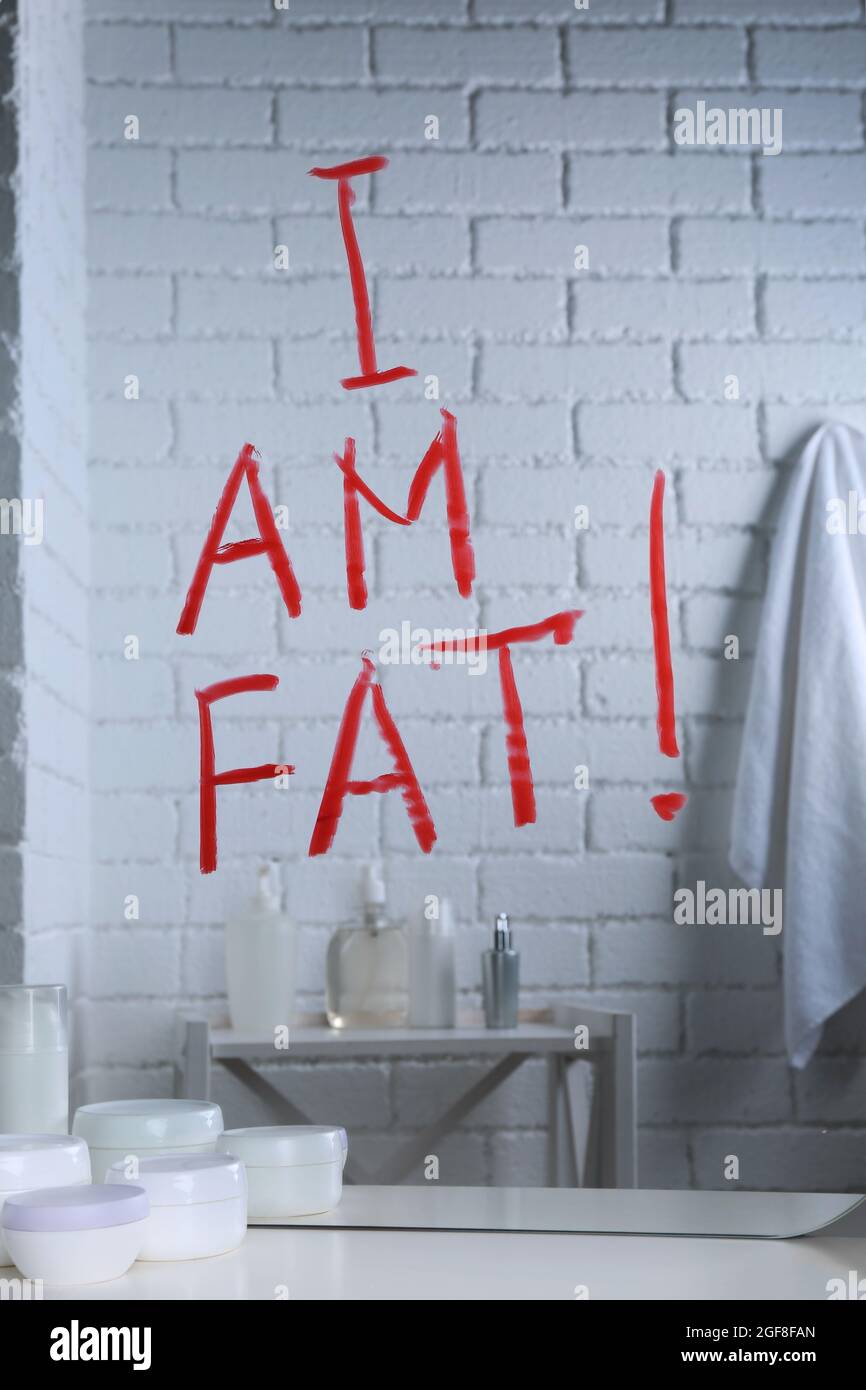 Text I AM FAT written on mirror in the bathroom Stock Photo - Alamy