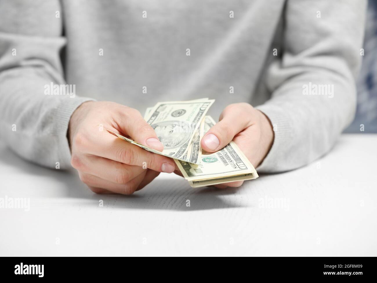 Man counting money and making calculations Stock Photo - Alamy