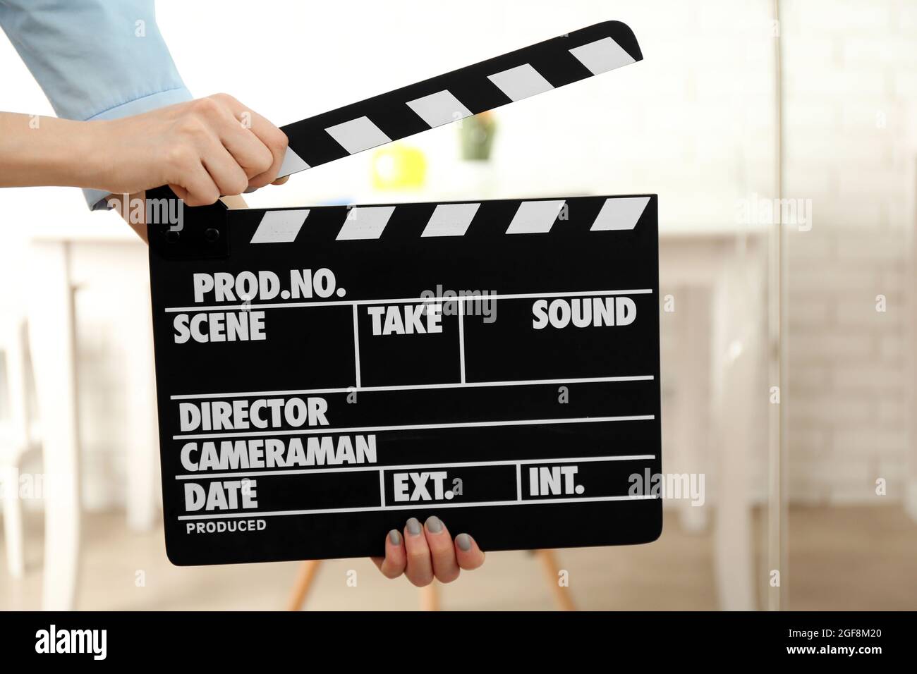 Woman hands holding film clapper, close up Stock Photo - Alamy