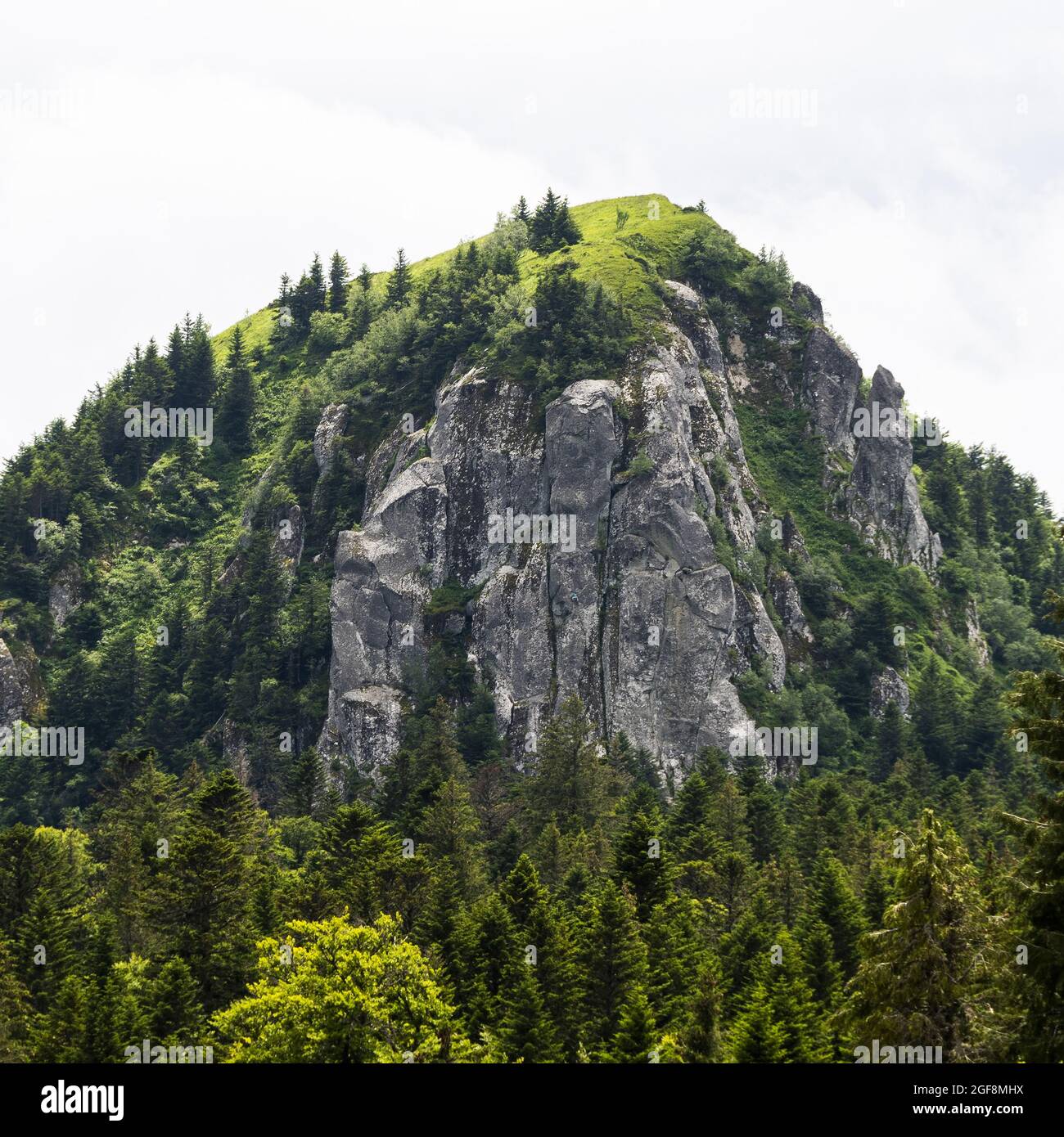 Beautiful landscape of a big rocky hill covered with grass and ...