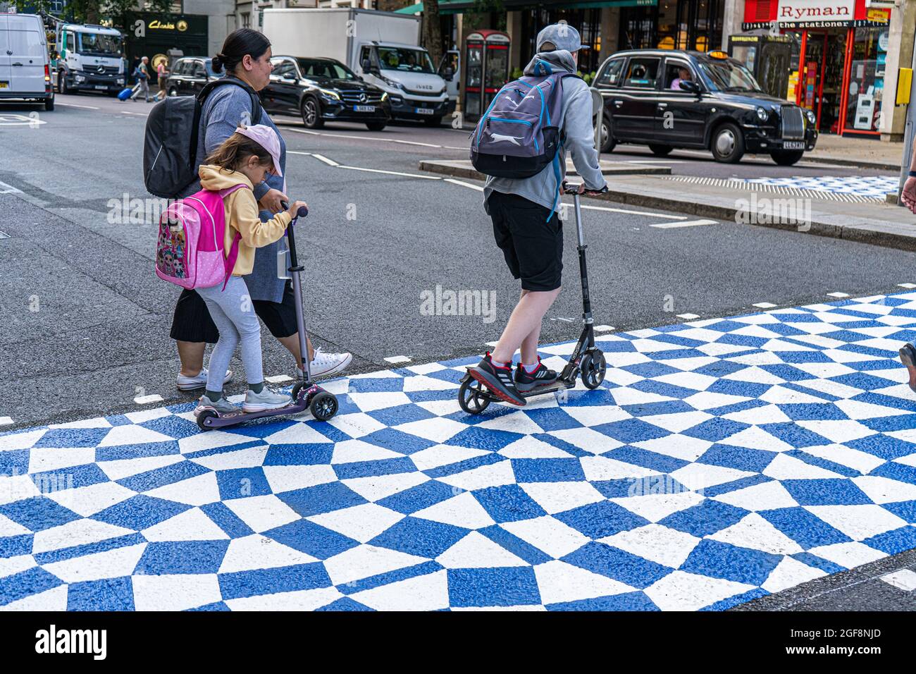 KENSINGTON LONDON, UK. 24 August 2021. Pedestrians using a creative ...
