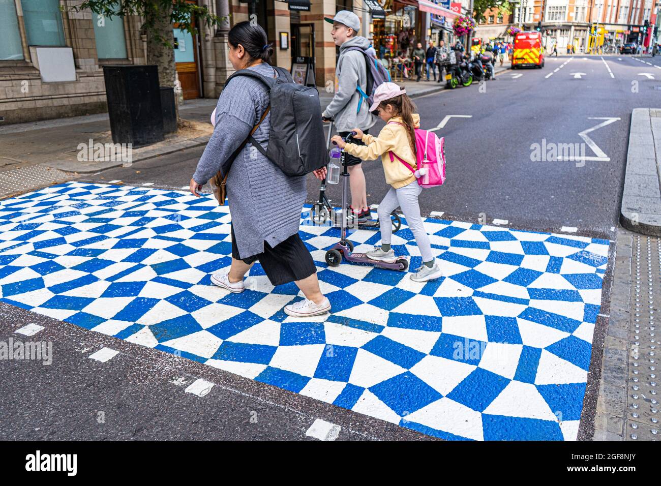 KENSINGTON LONDON, UK. 24 August 2021. Pedestrians using a creative ...