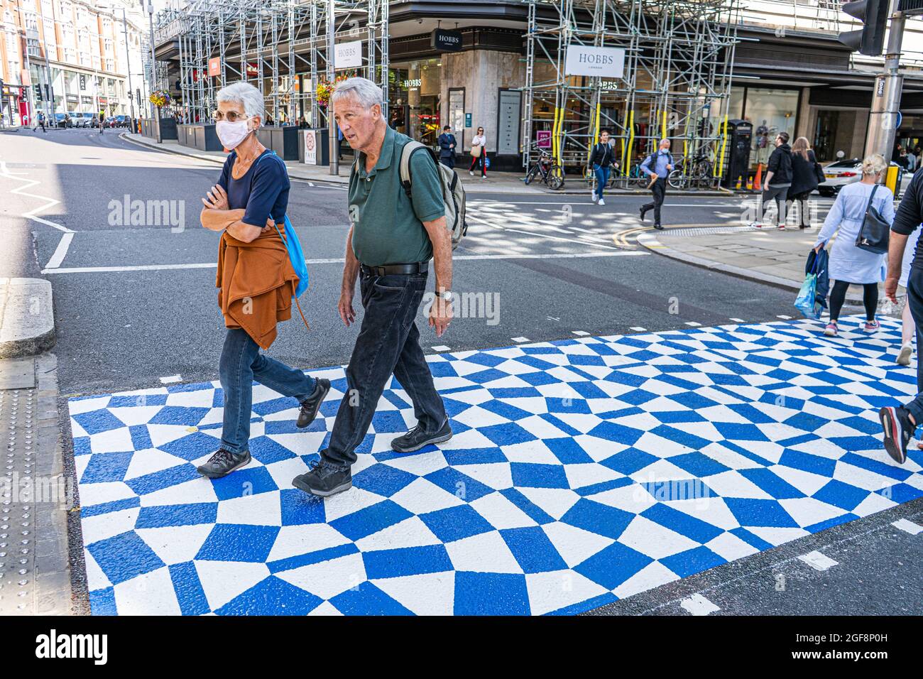 KENSINGTON LONDON, UK. 23 August 2021. Pedestrians using a creative ...