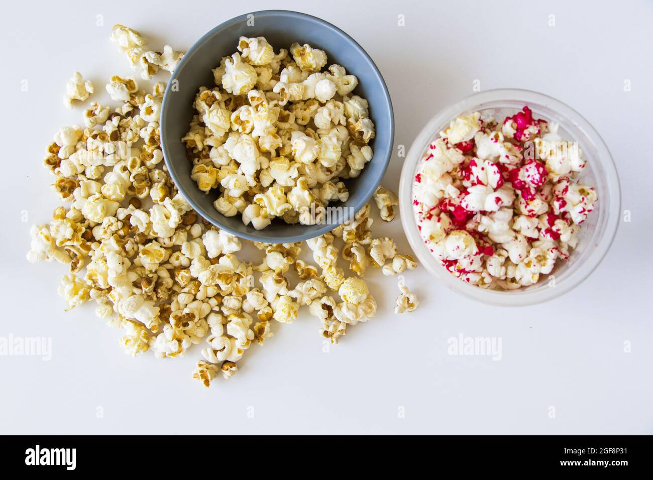 Top view of popcorn in bowls on a white background Stock Photo - Alamy