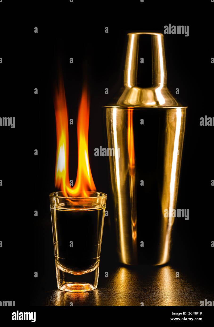 glass of flaming alcoholic drink, vodka or liquor on fire, black ...
