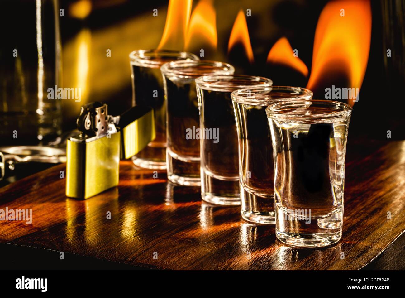glasses with tequila shots on fire, flaming drink, bar setting Stock ...