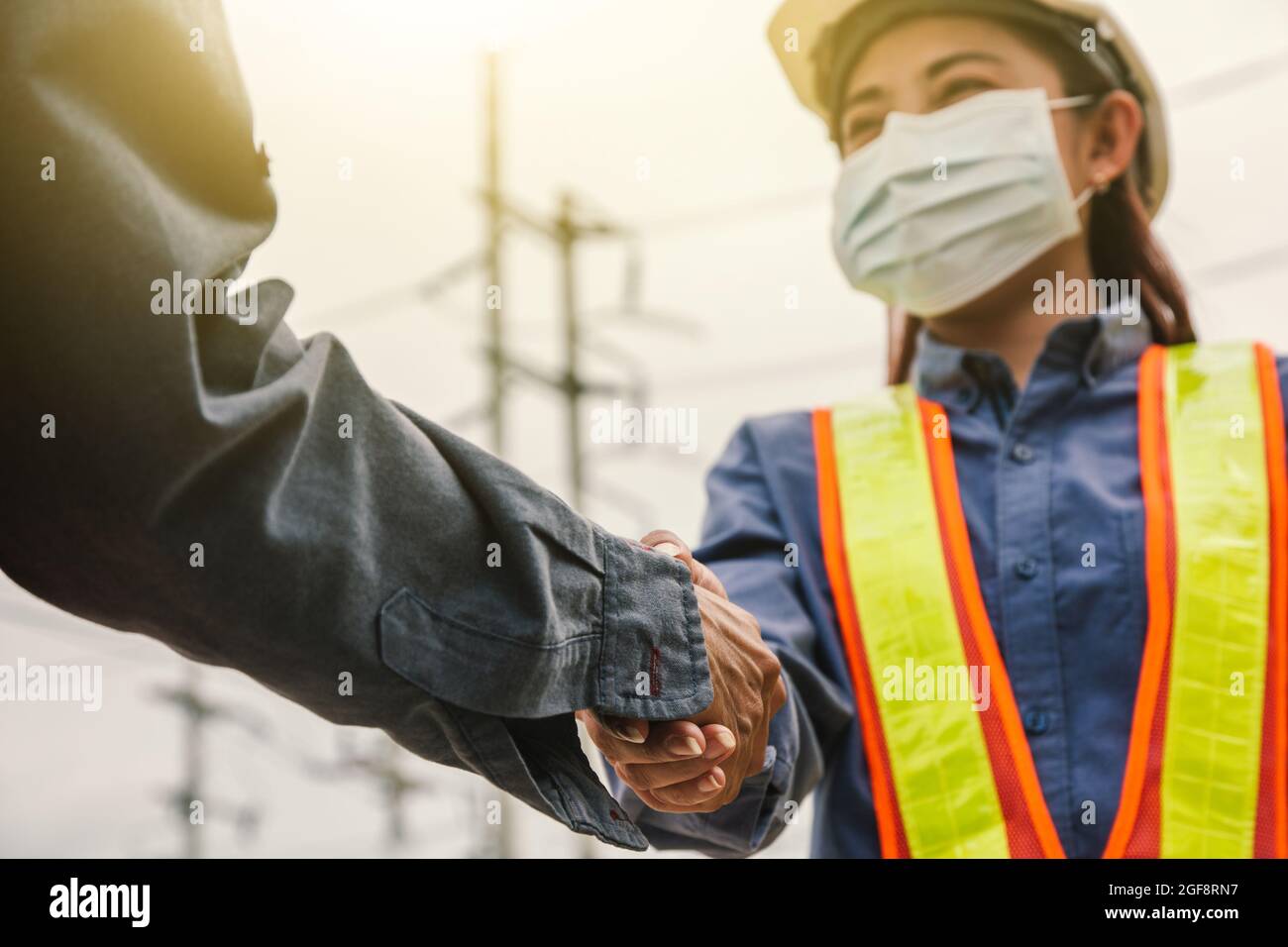 Closeup women engineer shake hand teamwork on site work success ...
