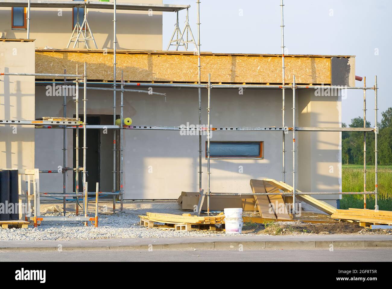 Construction waste in front of an unfinished building. rubbish in front ...