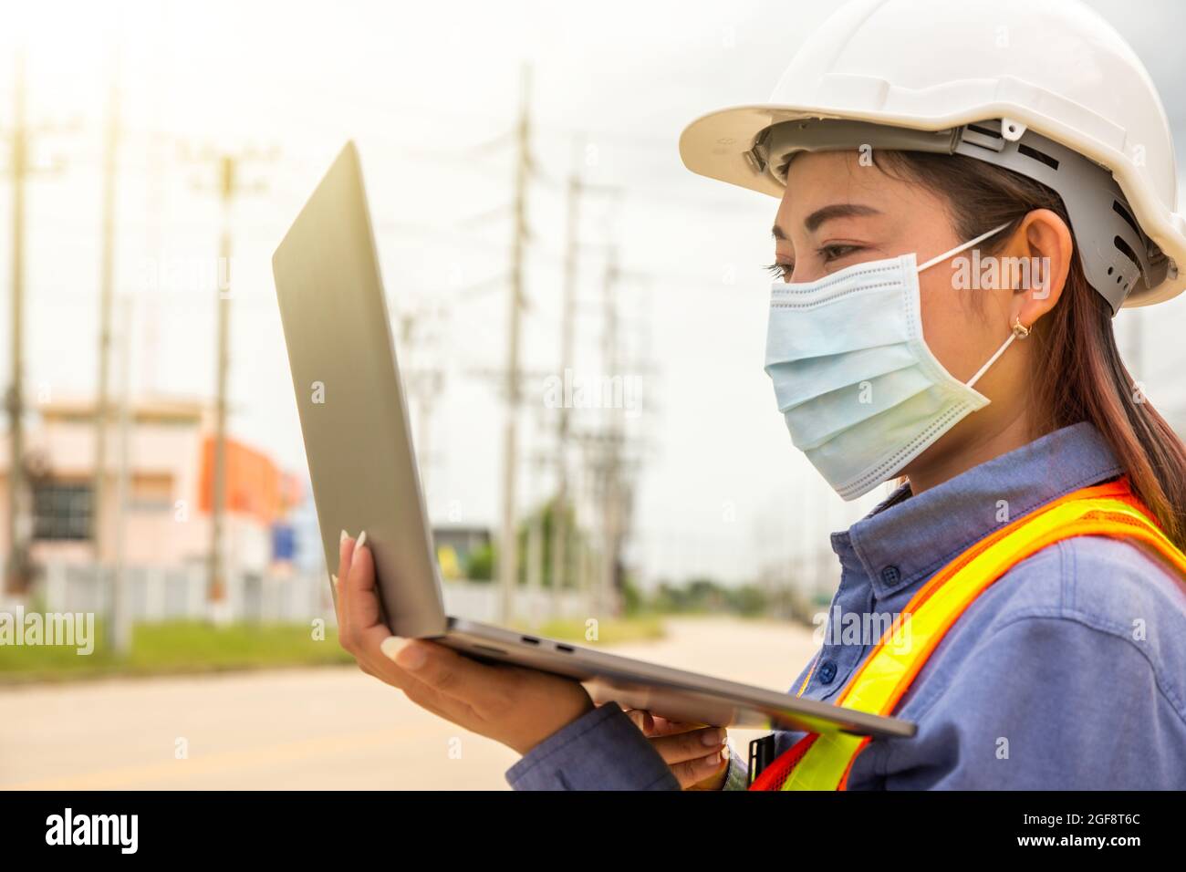 Women Electricity Engineer Working on site service with computer Stock ...