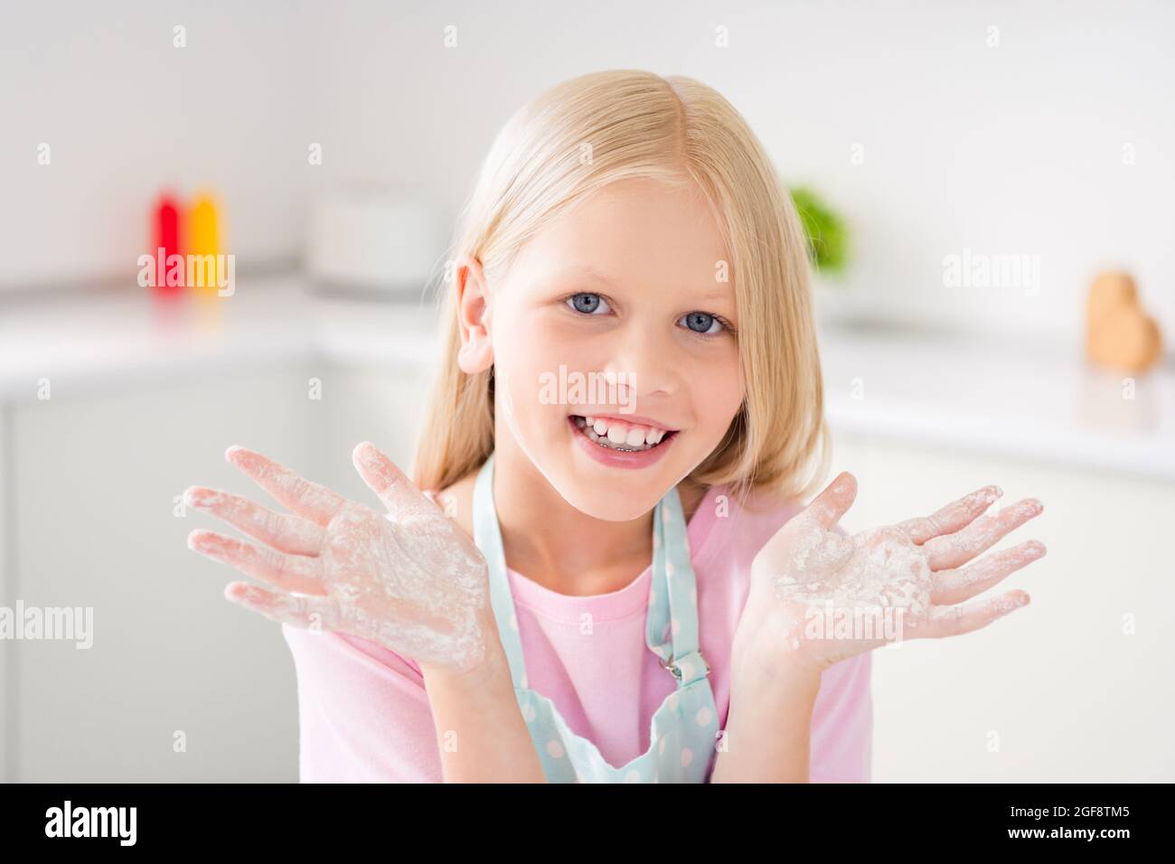 Photo of happy joyful young small girl hands flour smile wear apron ...