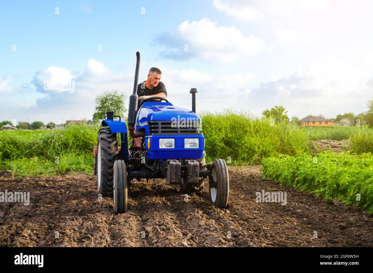 Farmer on a tractor works in the field. Seasonal worker. Recruiting ...
