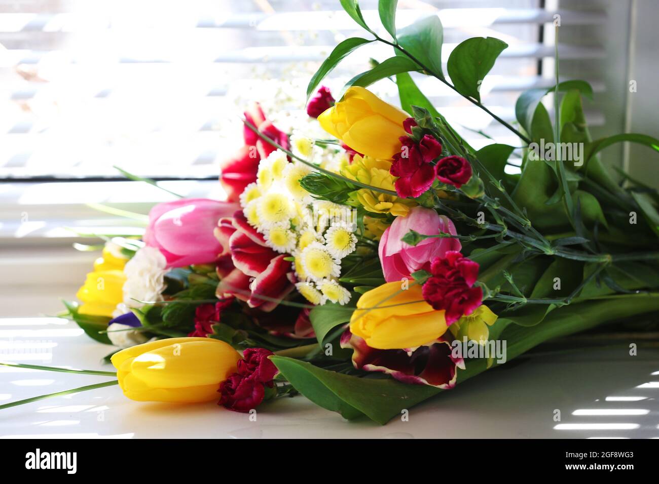 Bouquet of fresh flowers by the window Stock Photo - Alamy