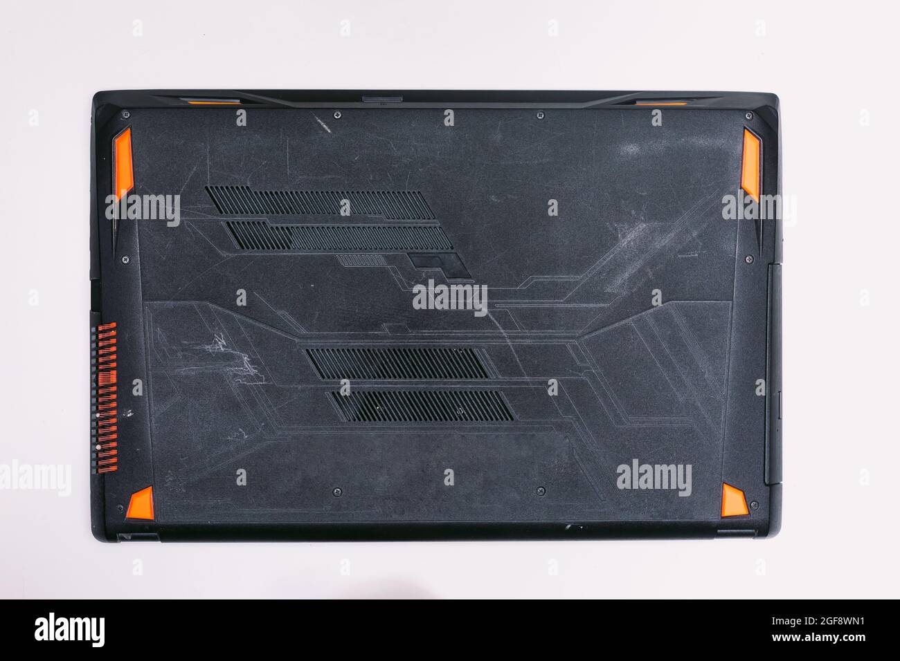 Top view of the underside of a laptop before being repaired on a white ...