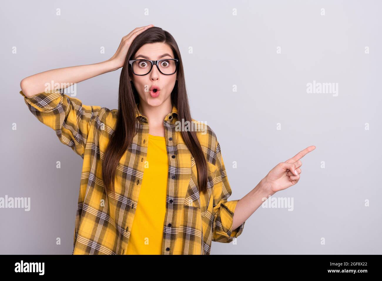 Photo of young girl amazed shocked omg wow point finger empty space ads ...