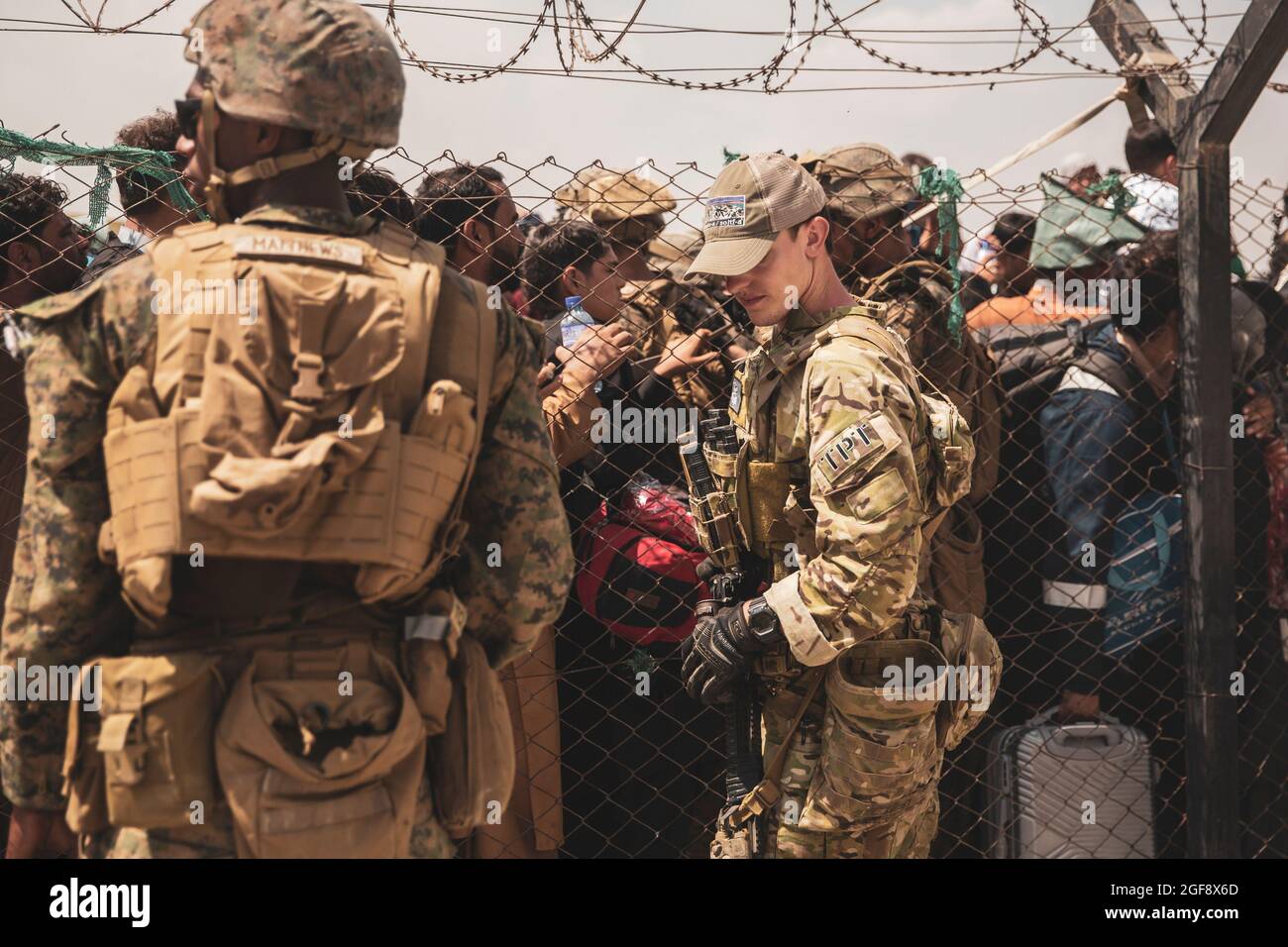 U.S. Marines and coalition soldiers maintain security at a evacuation ...