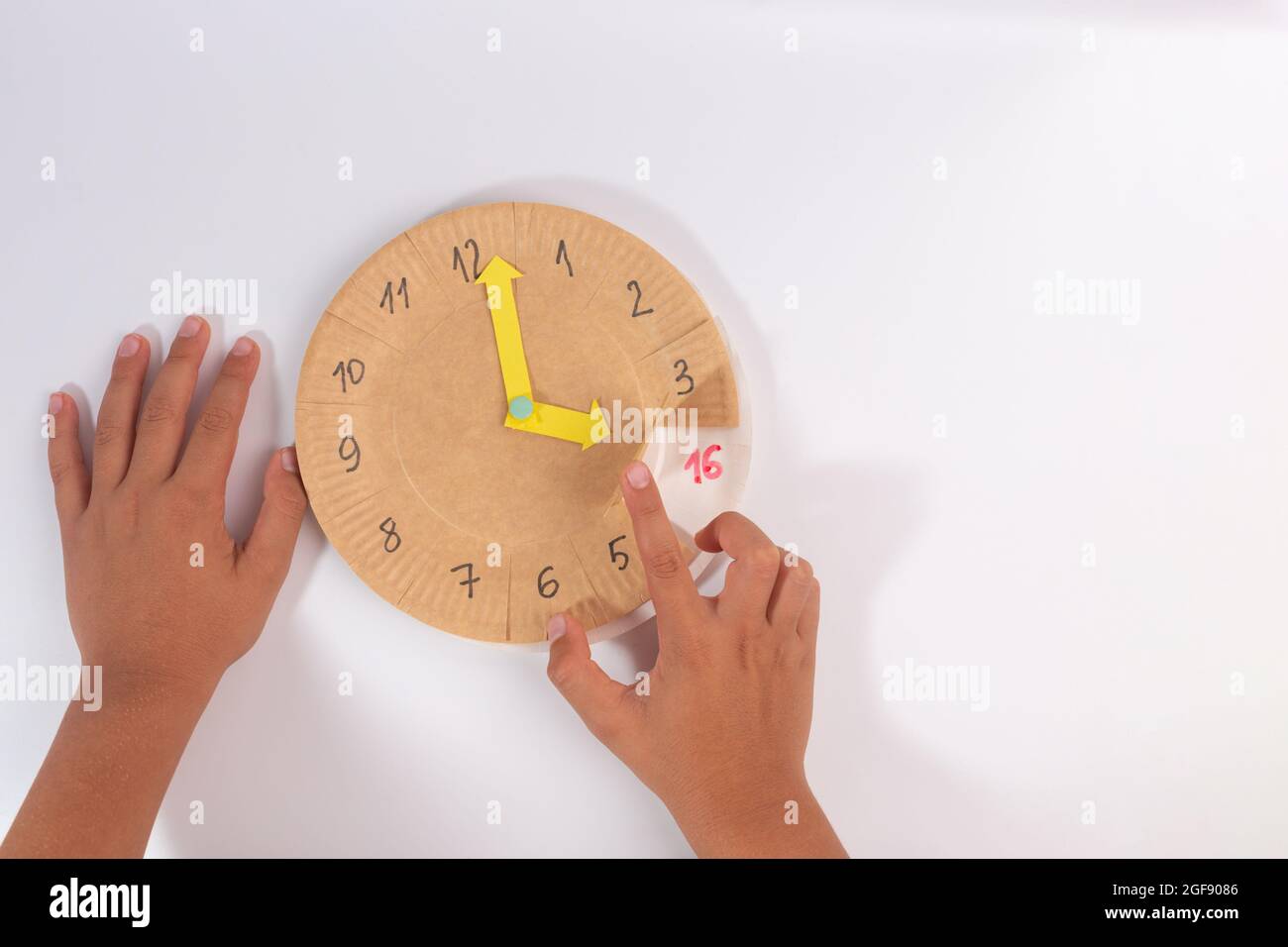 kids learns to tell time on handmade clock toy Stock Photo - Alamy