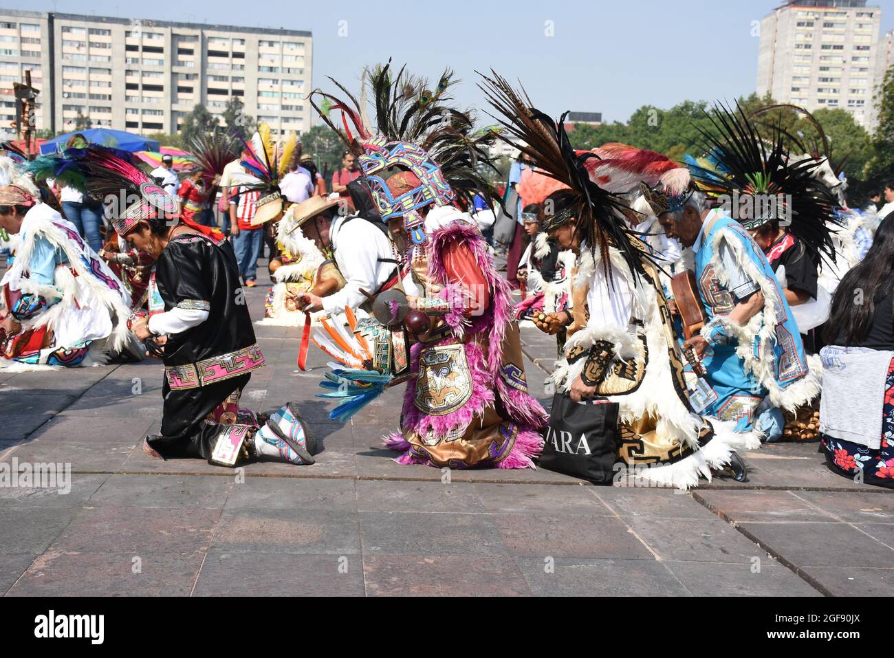 Concheros—traditional musicians and dancers—kneeling before an altar to ...