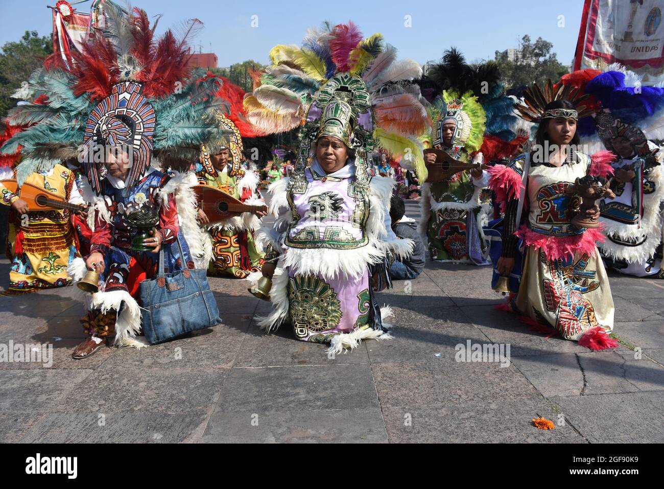Concheros—traditional musicians and dancers—kneeling before an altar to ...
