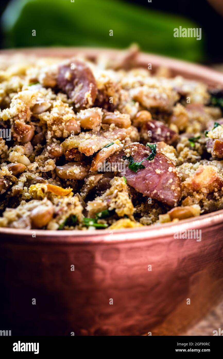Brazilian culinary dish, beans with pork, pepperoni, farofa and ...
