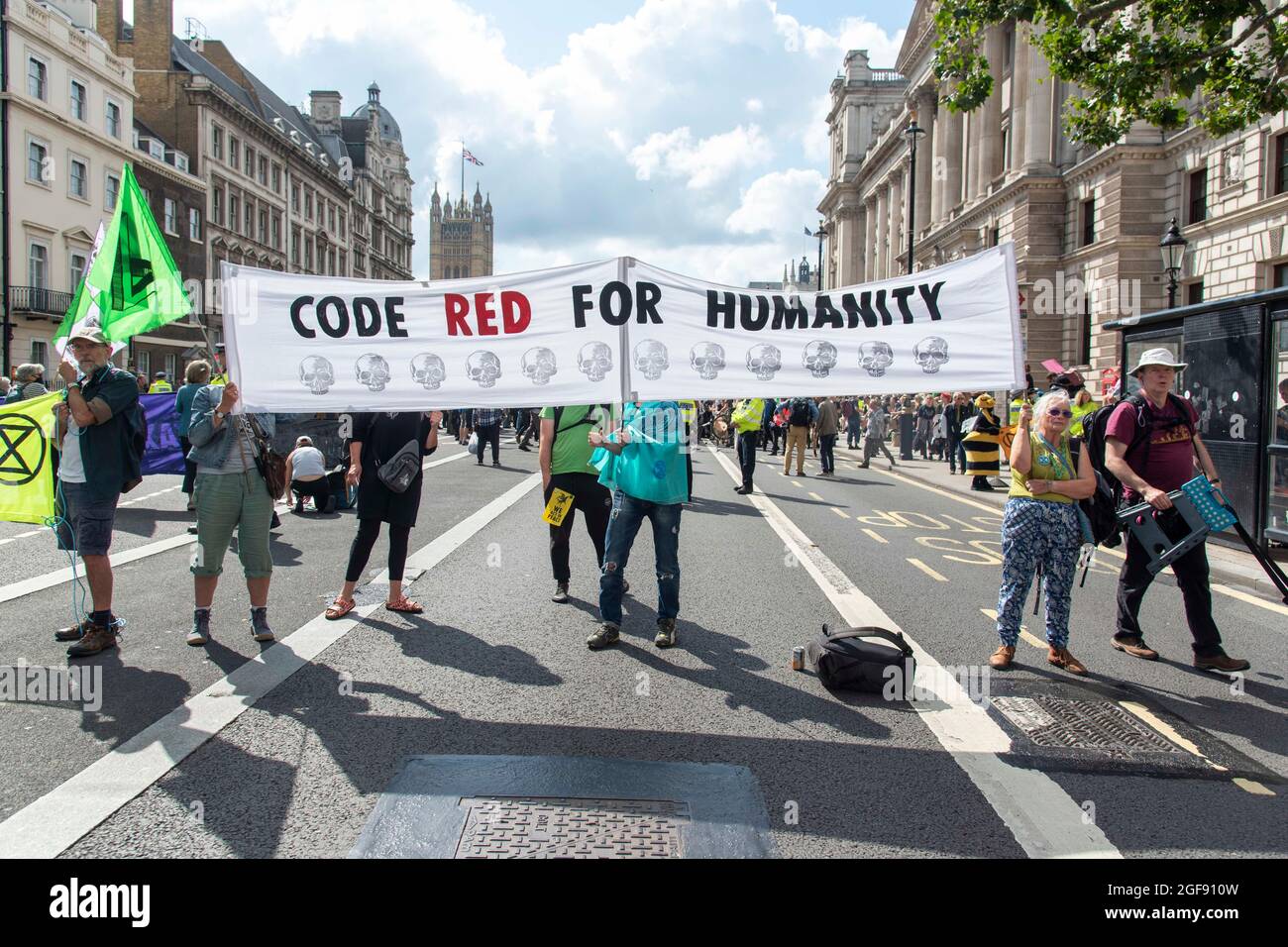 London, UK. 24th Aug, 2021. People holding a banner which reads, code ...