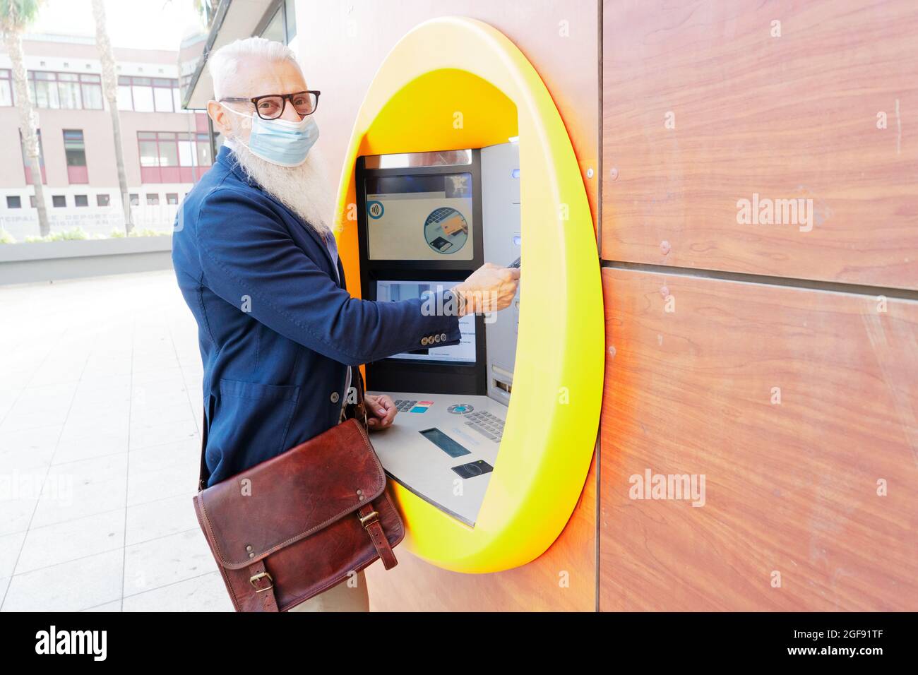 Senior man with ATM Stock Photo - Alamy
