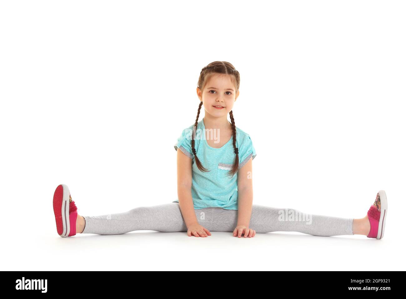 Little girl gymnast sitting on Cut Out Stock Images & Pictures - Alamy