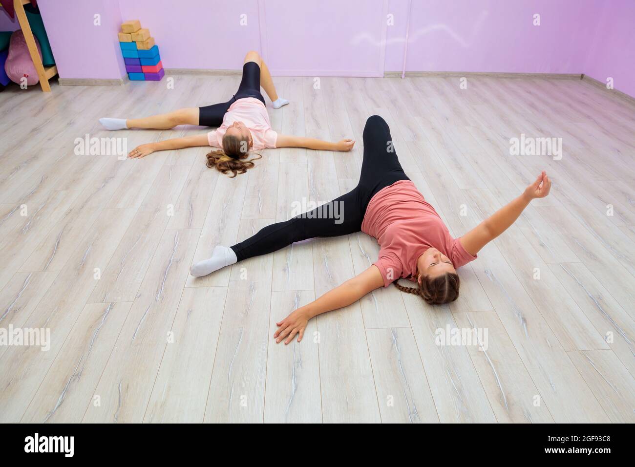Girl dance instructor shows the elements of the number to another girl ...