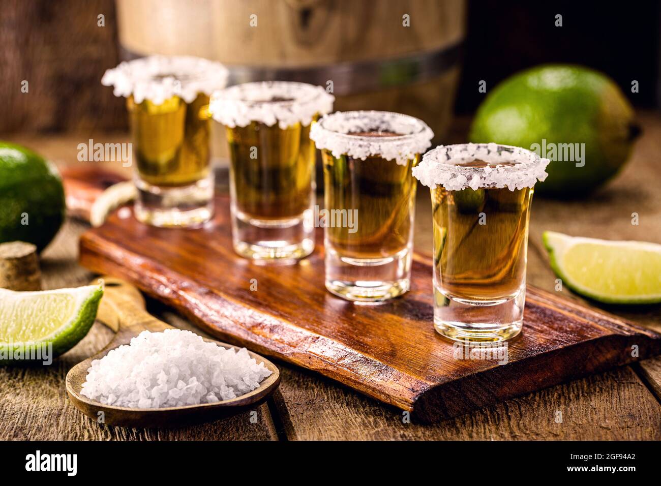 glasses of tequila on the bar table, served with salt and lemon Stock ...