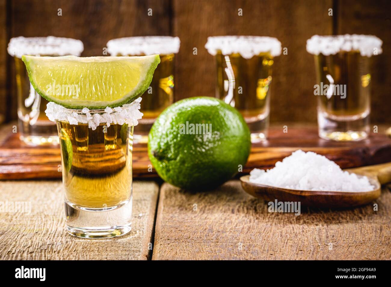 glasses of tequila on the bar table, served with salt and lemon Stock ...