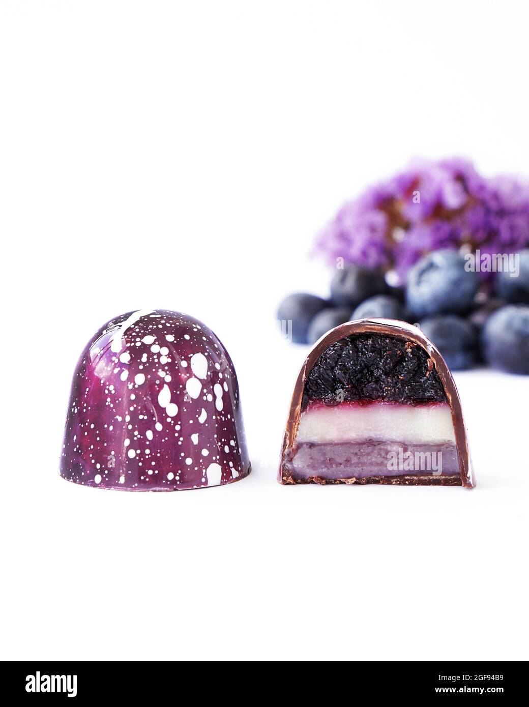 Chocolate candy in a cut on a white background. Blueberry and lavender ...