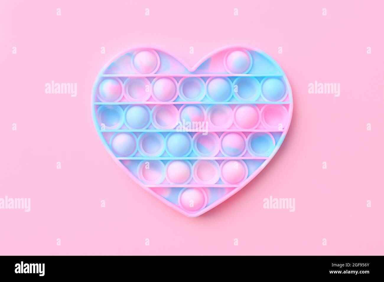 Colorful antistress sensory toy fidget push pop it on pink background ...