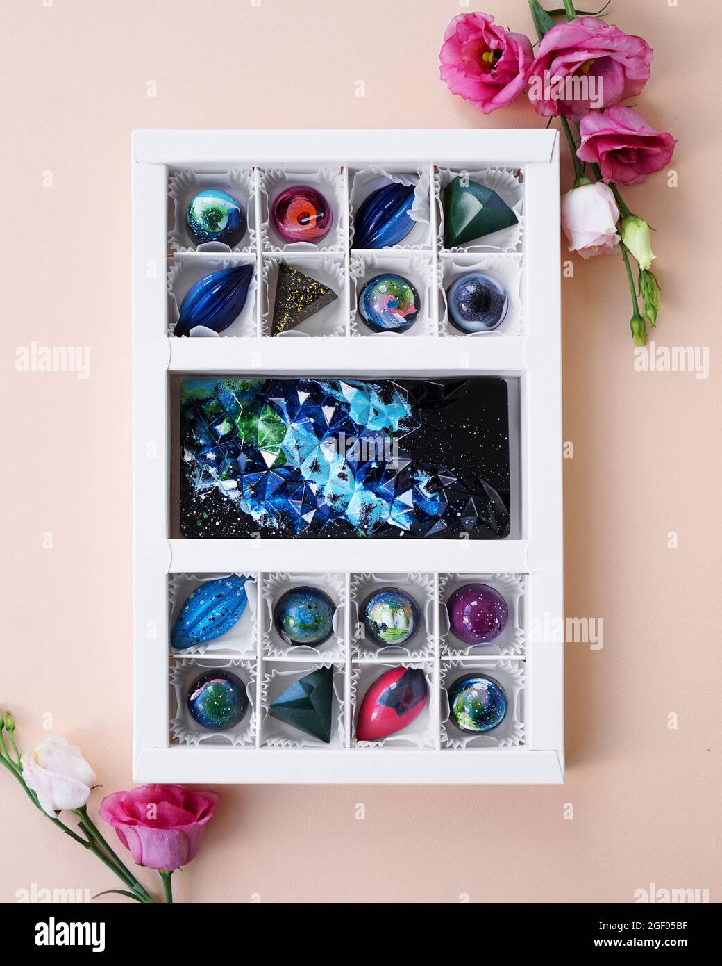 A set of handmade candies in festive packaging. Space design. Candy on ...