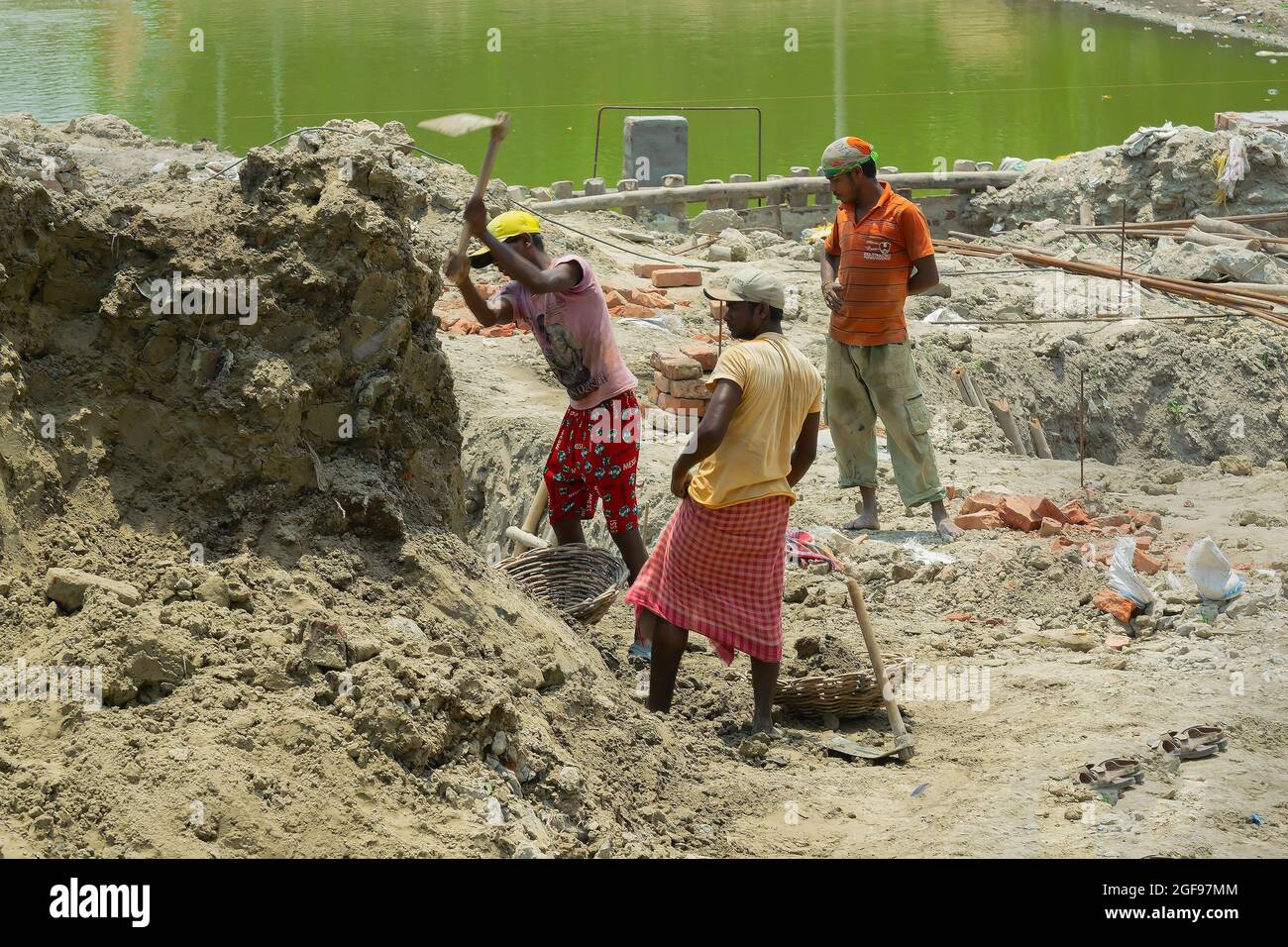 Howrah, West Bengal, India - 7th May 2017 : Indian male workers digging ...