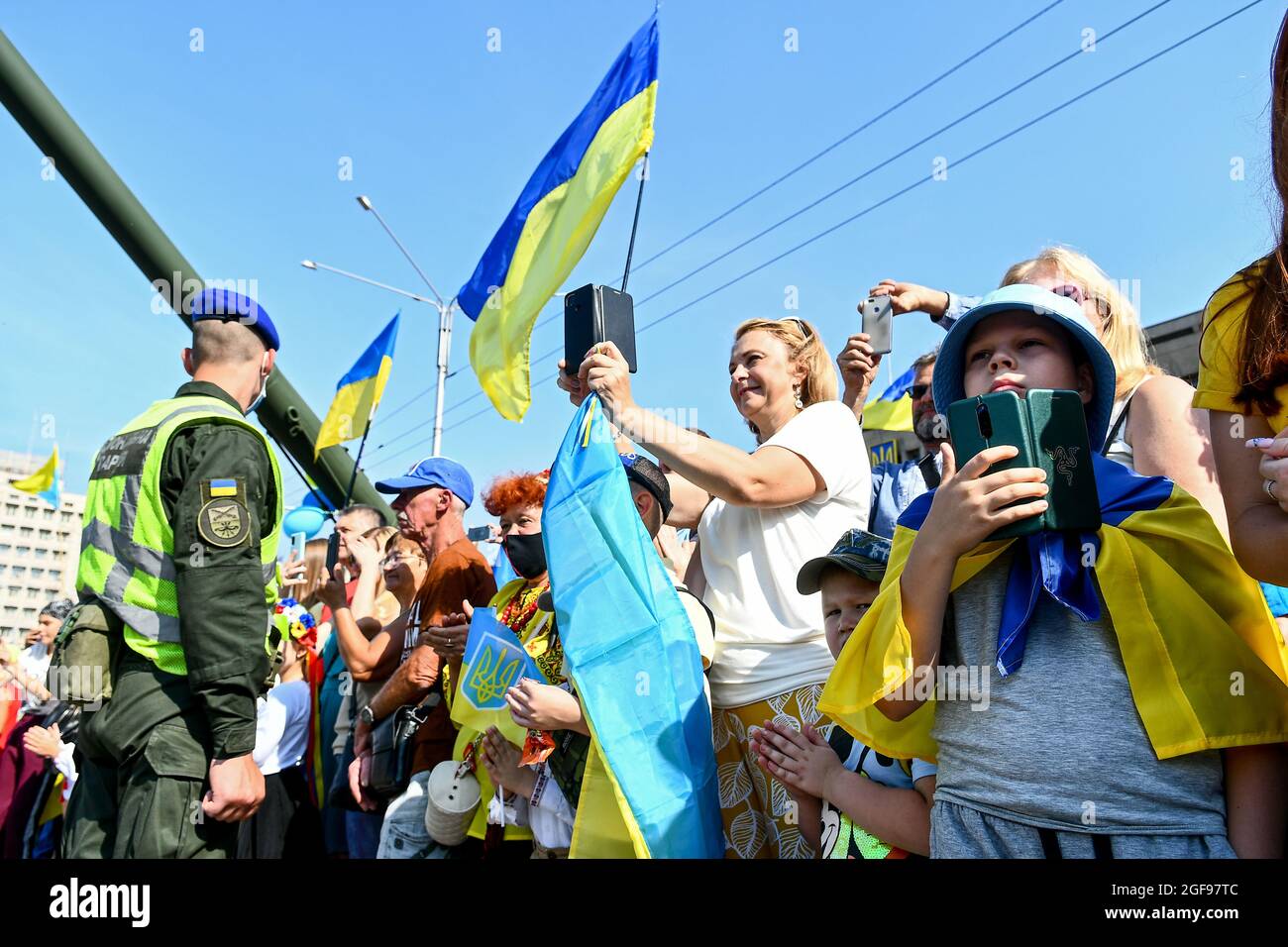 ZAPORIZHZHIA, UKRAINE - AUGUST 24, 2021 - Adults and children carrying ...