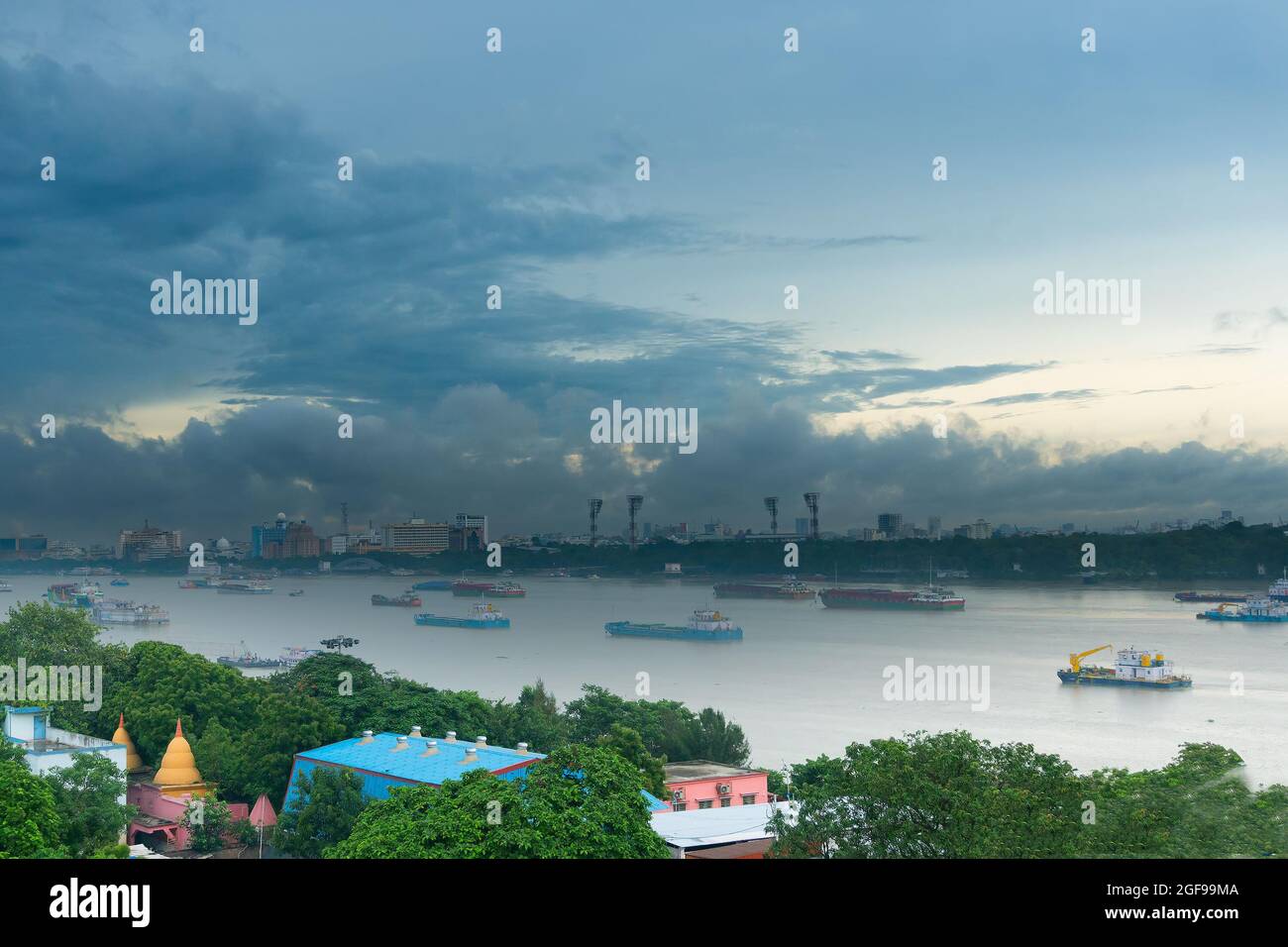 View of historical Howrah city. Green trees in foreground covering ...
