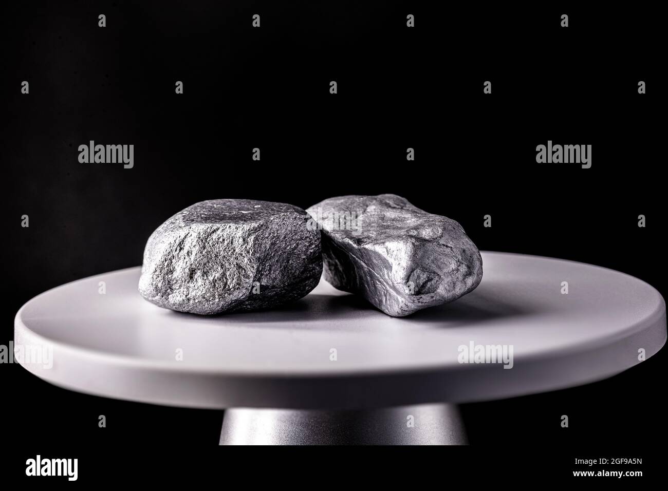 Manganese stones on electronic scale. Metal used in industry. Mineral ...