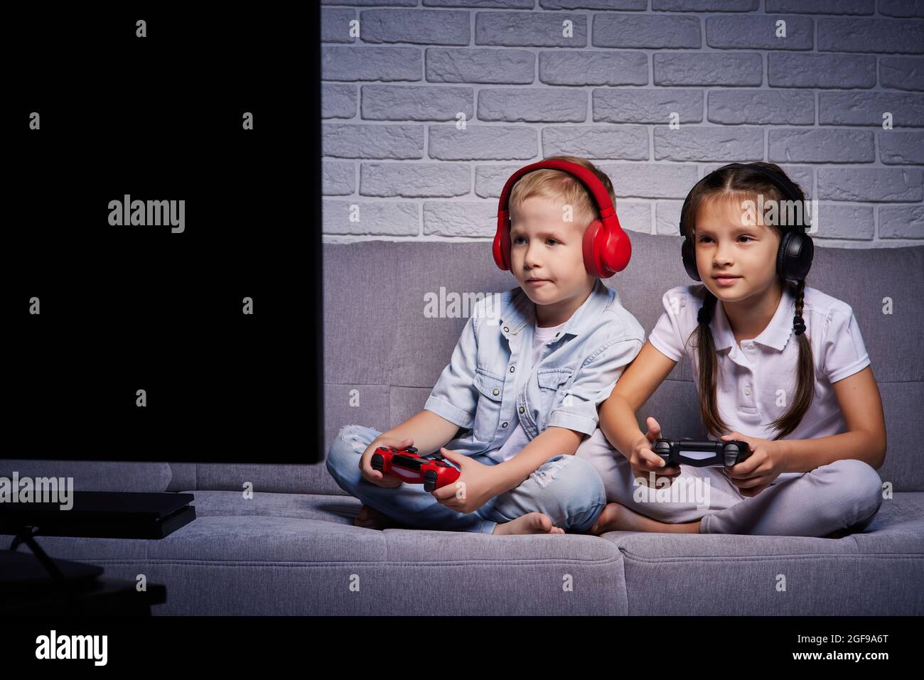 children playing video game with game console Stock Photo - Alamy