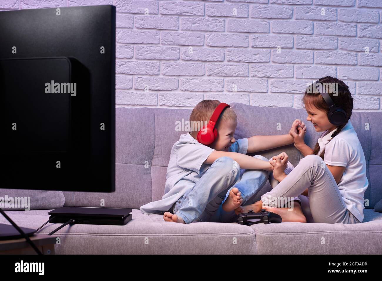children playing video game with game console Stock Photo - Alamy