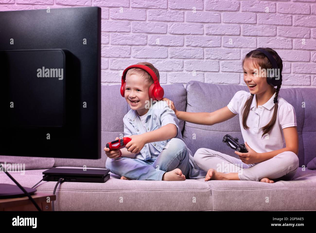 children playing video game with game console Stock Photo - Alamy