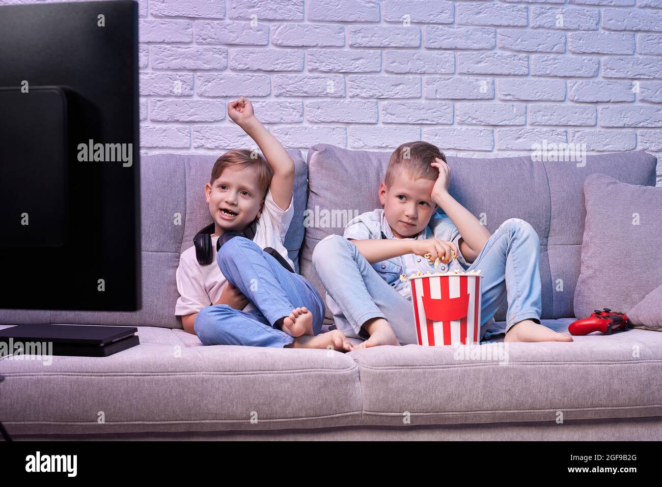 children playing video game with game console Stock Photo - Alamy
