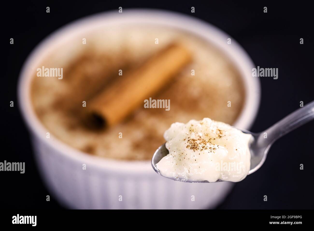 Spoon with rice pudding with defocused jam jar in the background Stock ...