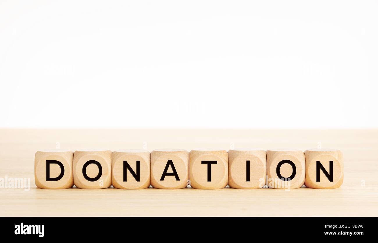 Donation word on wooden block shape. Copy space. White background Stock ...