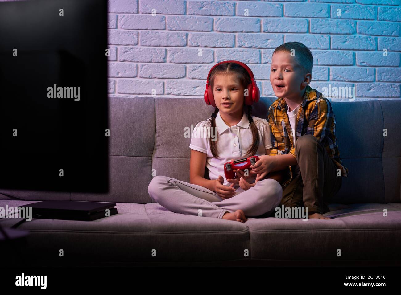 children playing video game with game console Stock Photo - Alamy