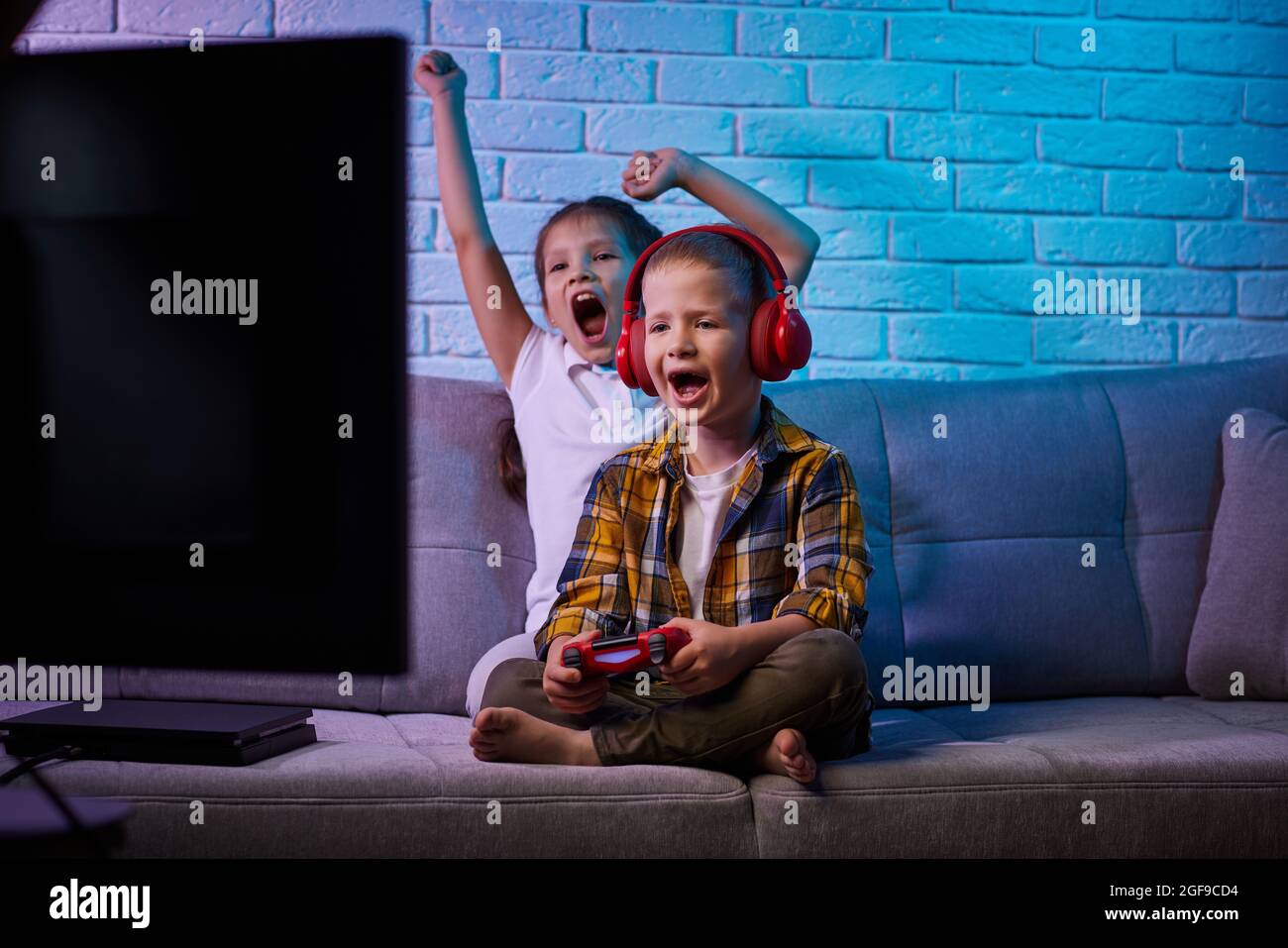 children playing video game with game console Stock Photo - Alamy