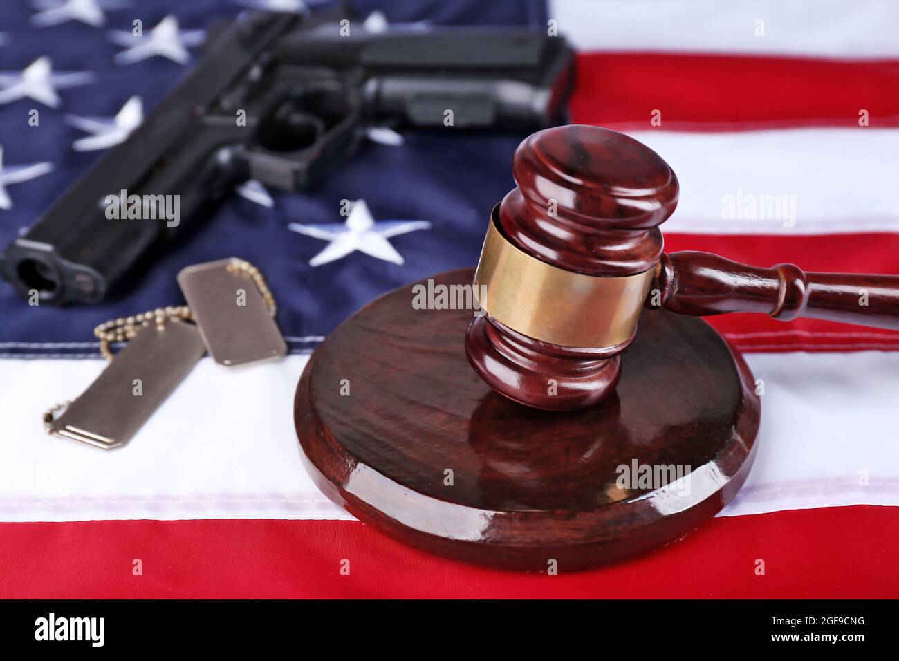 Gavel with gun and tokens on background of USA flag Stock Photo - Alamy