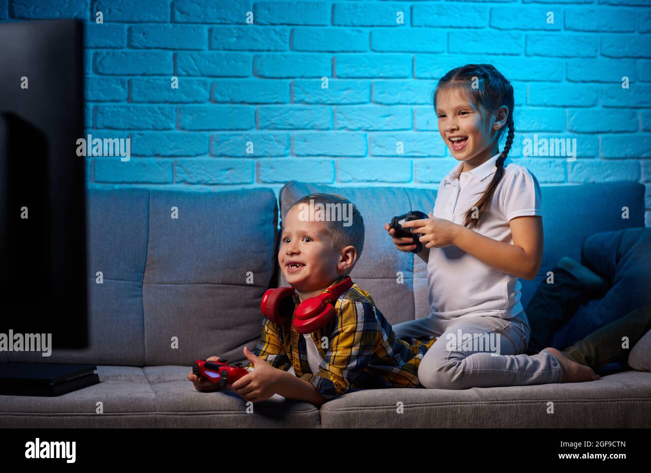 children playing video game with game console Stock Photo - Alamy