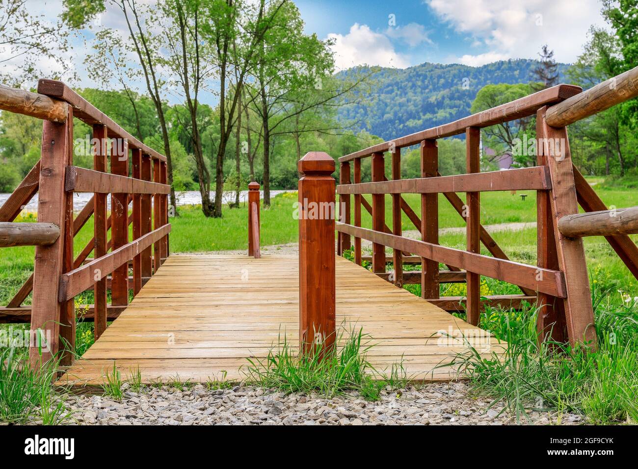 Wooden bridge in a park. Summer time Stock Photo - Alamy